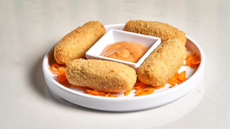 Golden brown fried croquettes with dipping sauce