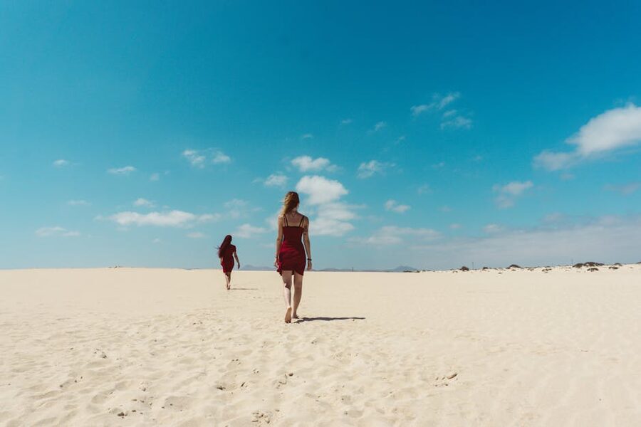 Two people walking on Corralejo beach