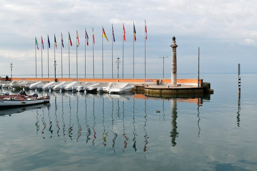 Garda town harbour with international flags and boats