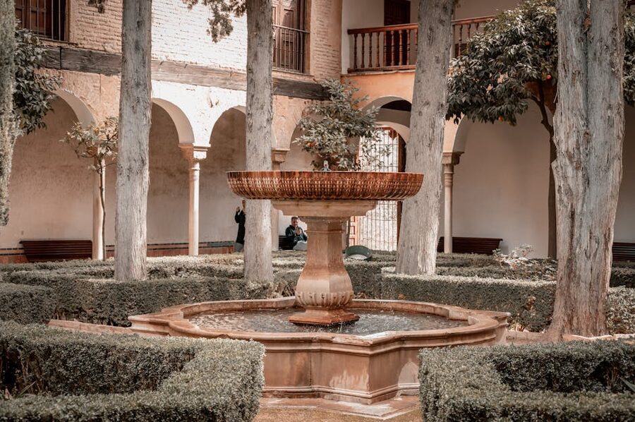 Fountain in courtyard of Alhambra with arches around