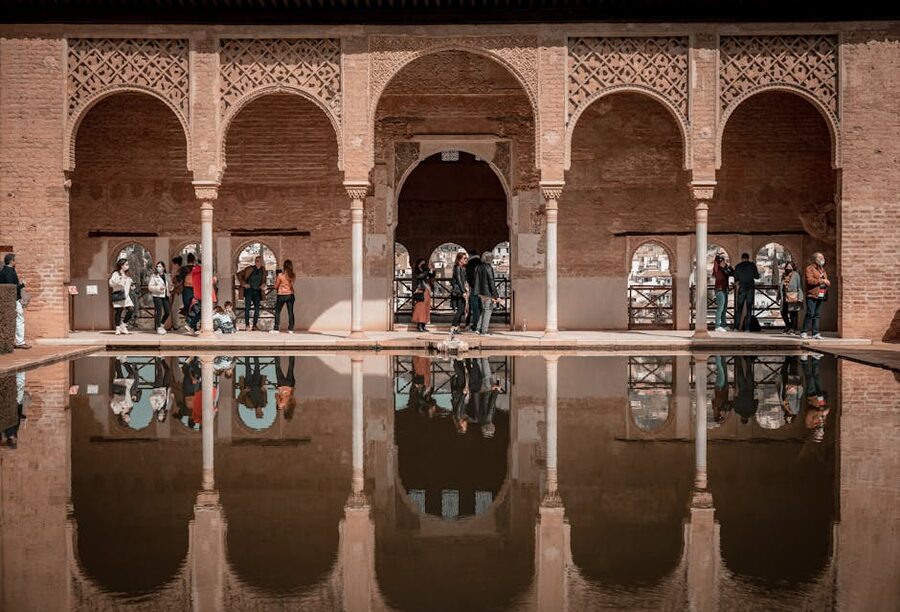 Tourists in arched corridor of the Nasrid Palaces
