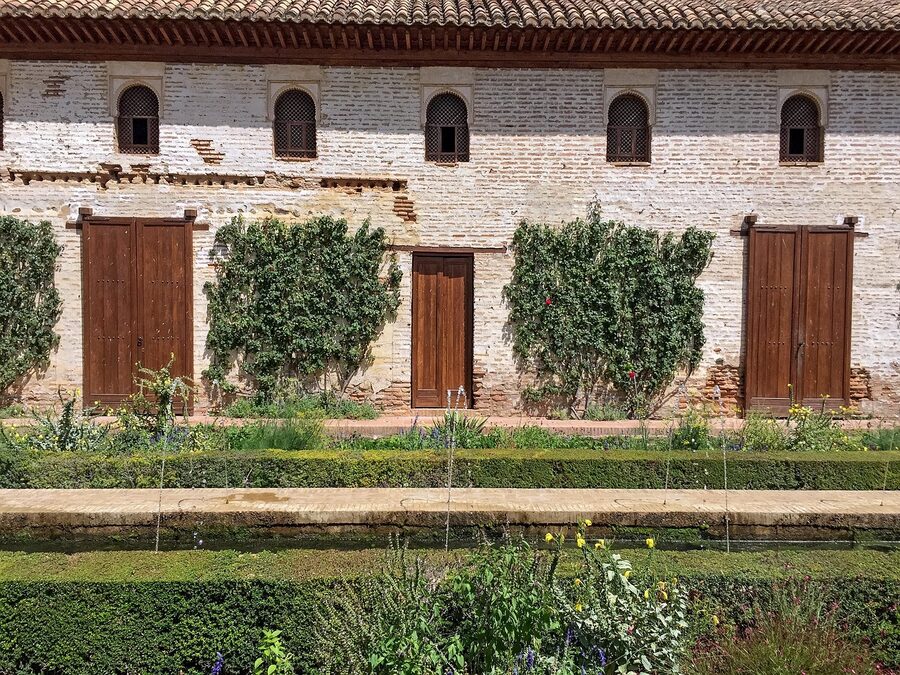 Long water channel in Generalife garden with arched pavilion