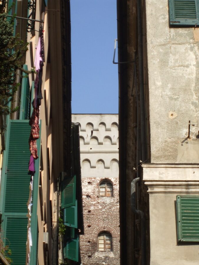 Glimpse down a Genoa caruggi alley with stone arch