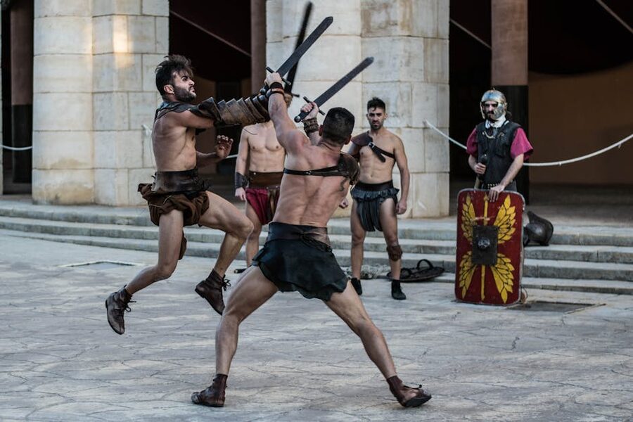 Two reenactors sparring with swords in a stylised arena