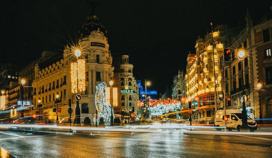 Gran Via Madrid lit up at night with festive lights and city traffic