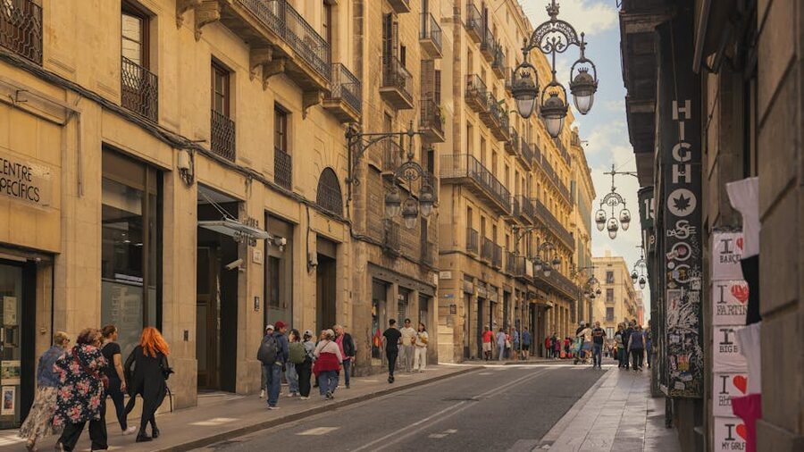 Barcelona historic quarter street with iconic lamps in the evening