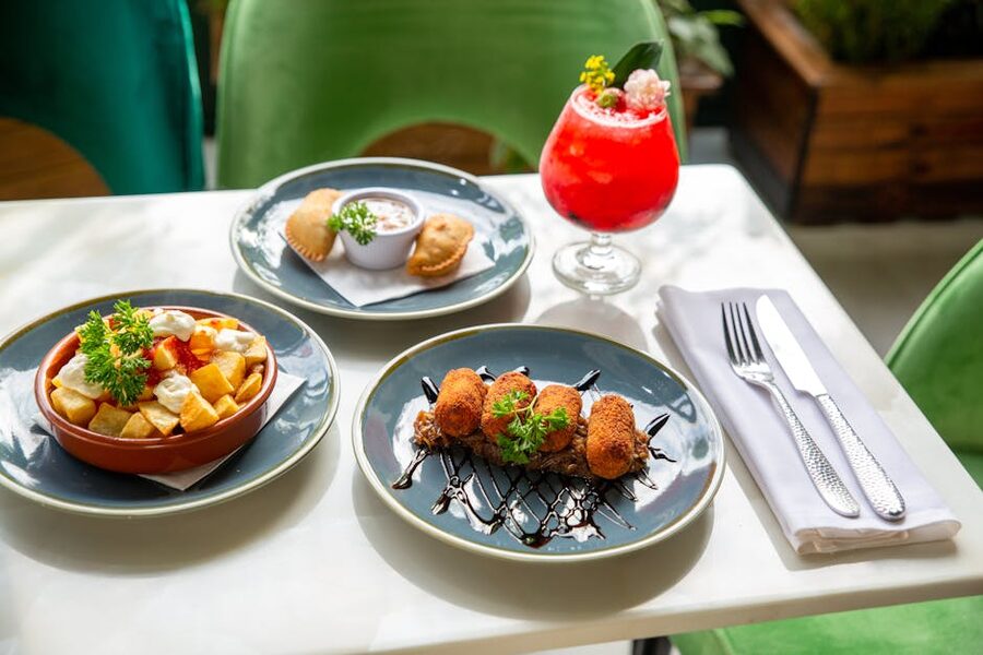 Spread of Spanish small plates with cocktail