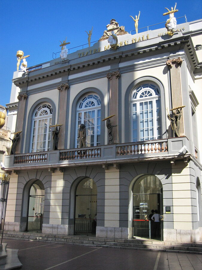 Exterior of the Dalí Theatre and Museum in Figueres with red walls and giant eggs on the roof