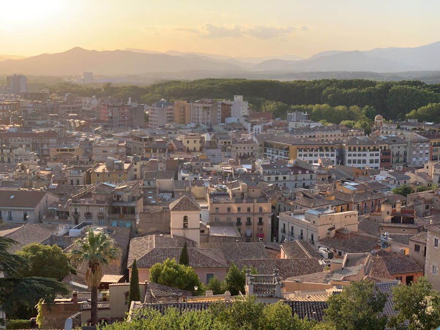 Girona cityscape at sunset with cathedral and mountains