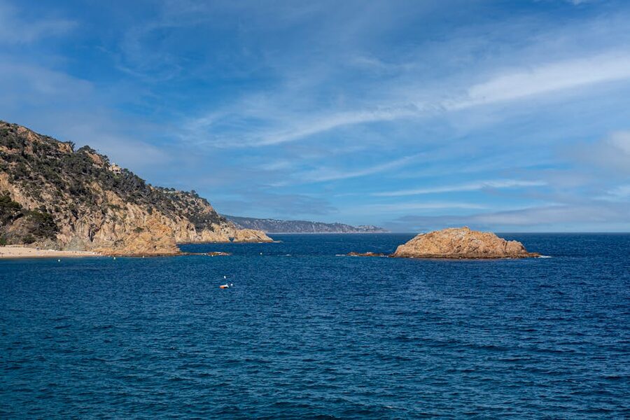 Rocky cliffs and azure water at Tossa de Mar Costa Brava