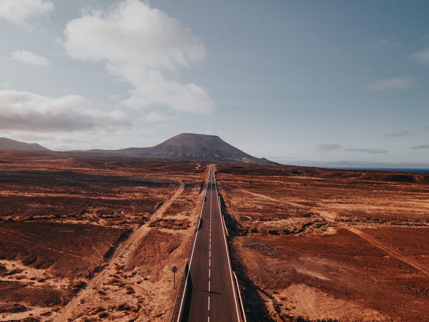 Aerial view of road stretching through Timanfaya volcanic landscape