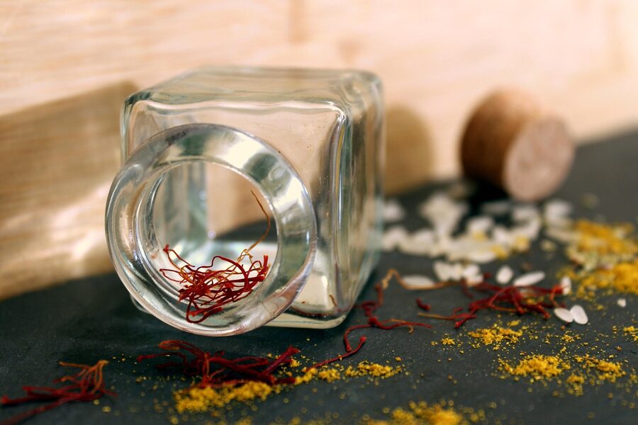 Saffron strands beside paella rice on a market stall