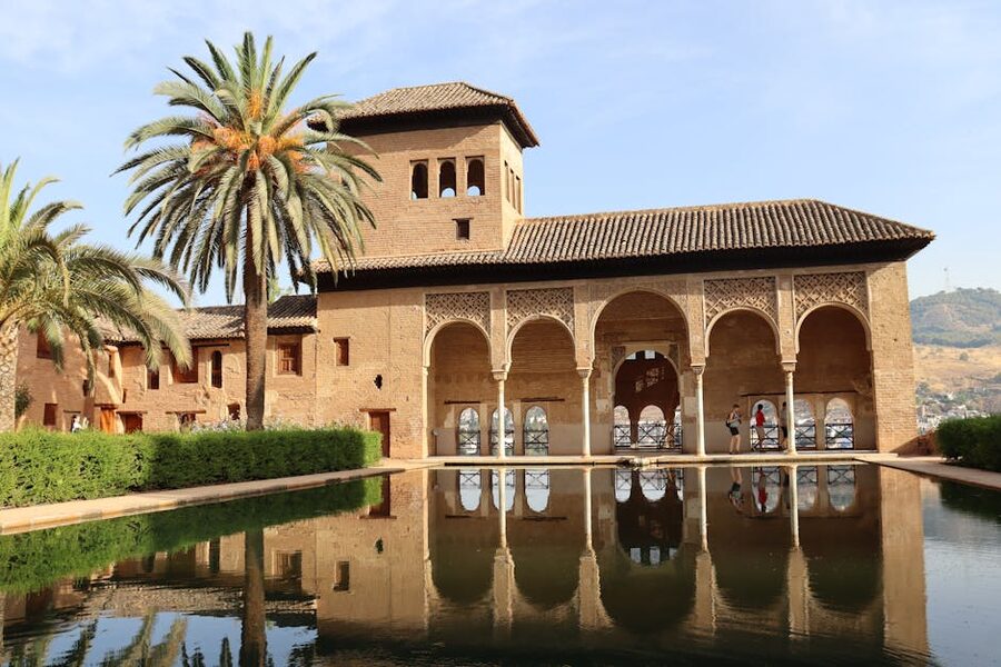 Alhambra Comares Palace reflecting pool palm trees Granada