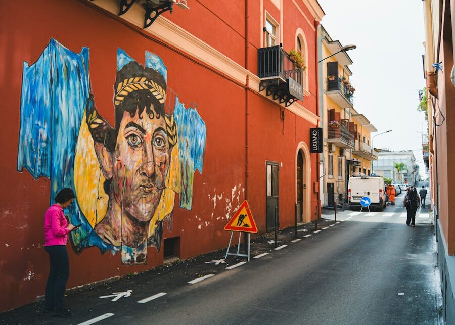 Italian alleyway with colorful street art and pedestrians