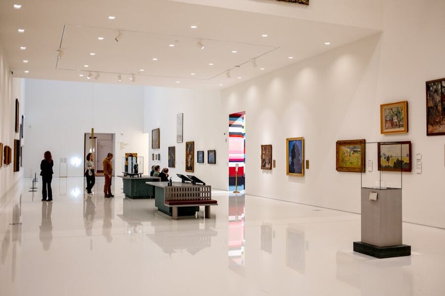 Modern art museum interior with visitors browsing exhibits