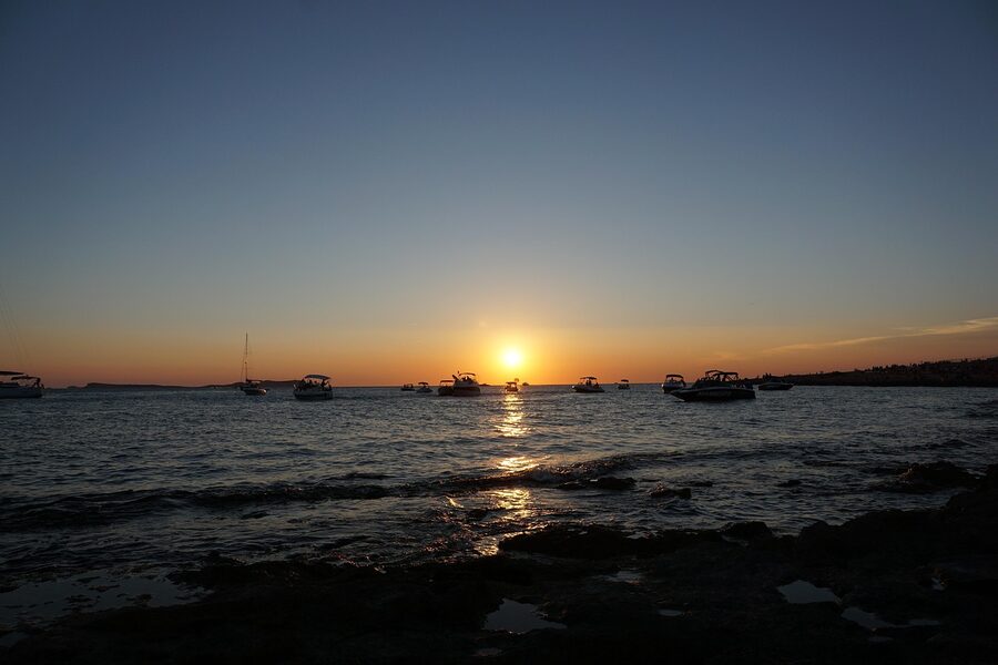 Sunset over Sant Antoni Ibiza with boats
