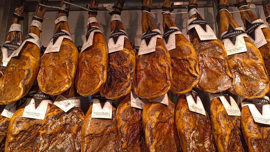 Jamon Iberico hams hanging in a traditional Spanish setting