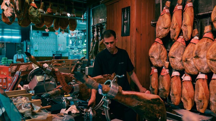 Slicing jamon iberico at a Spanish market counter