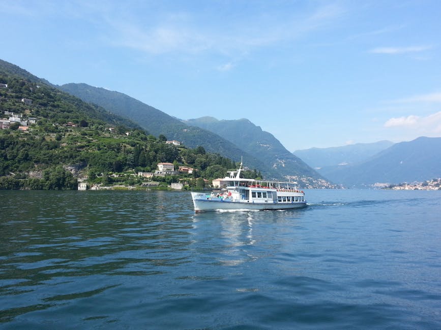 A Lake Como ferry cruising past lush hills in Lombardy