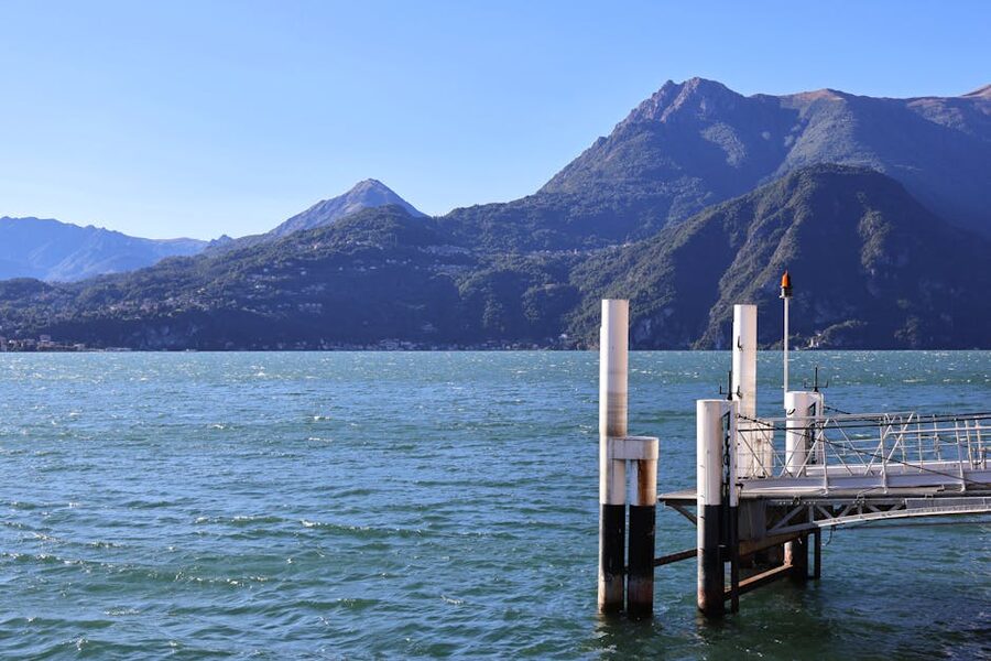 Lake Como pier with alpine mountains in the background