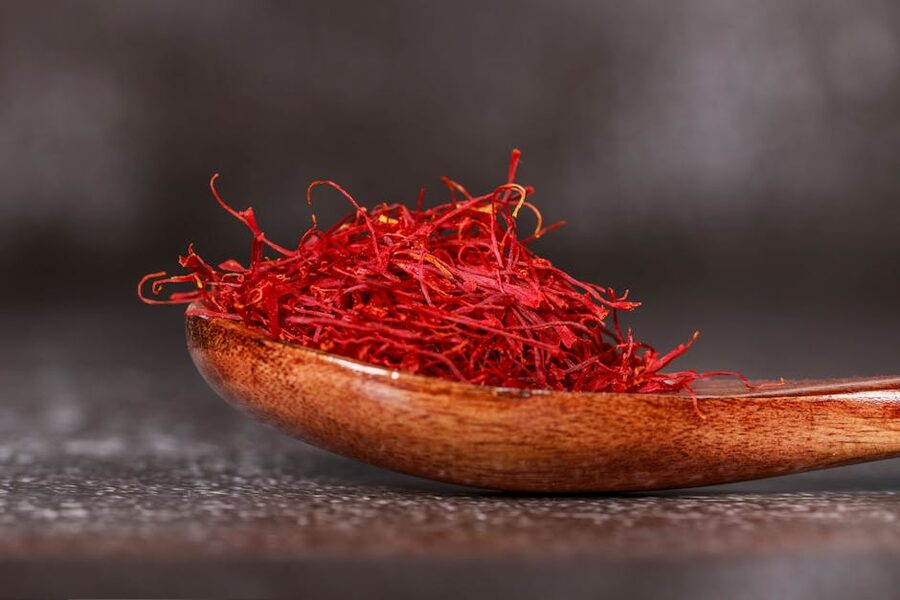 Saffron threads on a wooden spoon ready for a paella