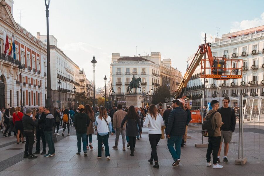 Crowded Madrid square with people walking and historic buildings