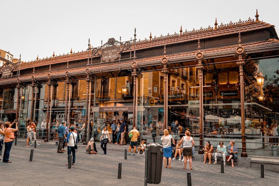 Inside Mercado de San Miguel Madrid with food stalls and visitors