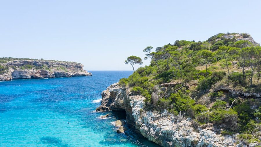 Rocky cliffs and clear sea on Mallorca's coast in summer