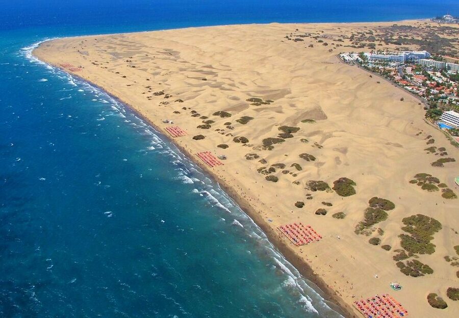 Aerial coastal view of Maspalomas dunes meeting the Atlantic