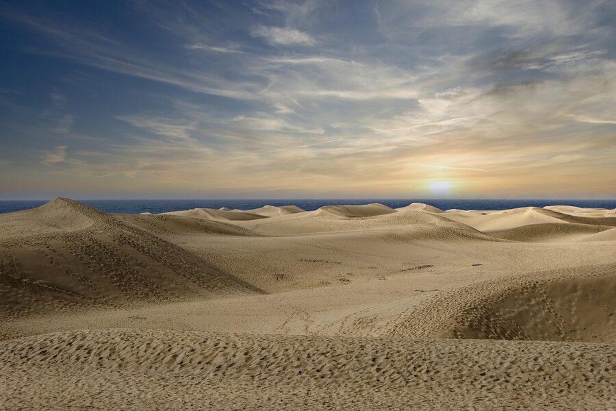 Maspalomas dunes with mountain backdrop and pale gold sand