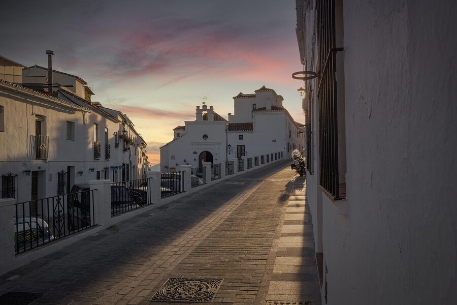 Mijas alley at sunset showing whitewashed historic buildings