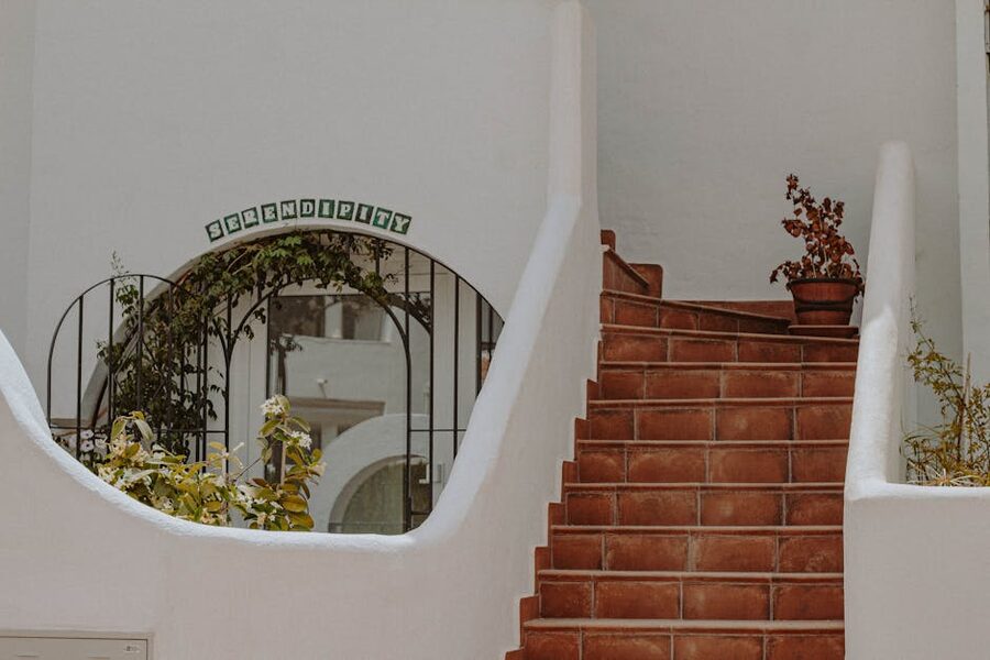 Rustic terracotta steps with potted plants in a Mijas alley
