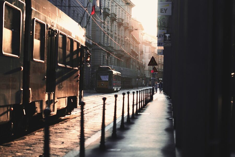 Milan tram passing through historic central streets near La Scala