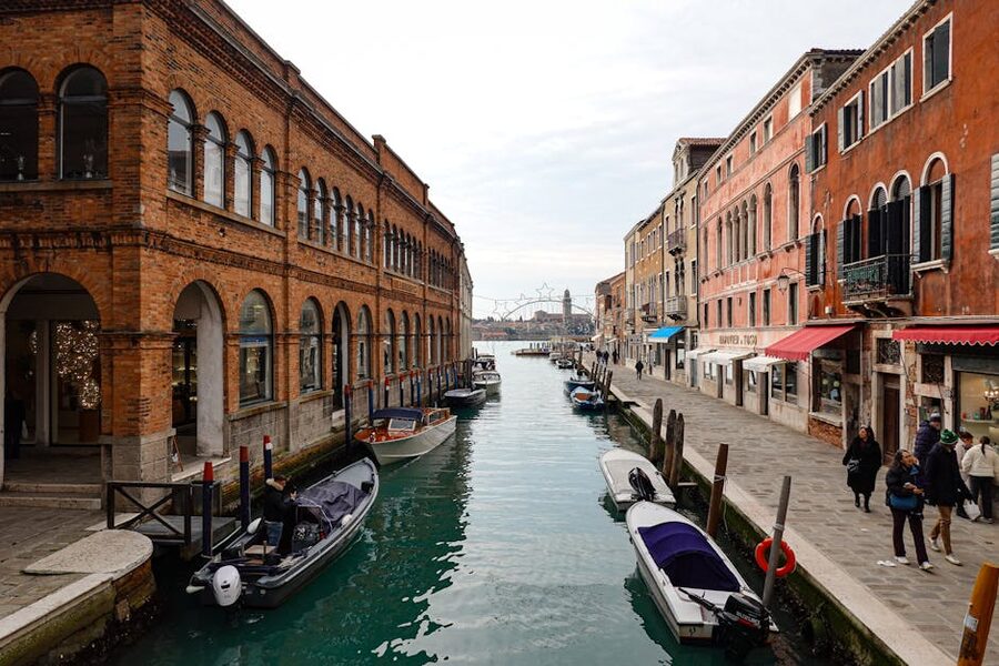 Murano canal lined with historic Venetian architecture and boats
