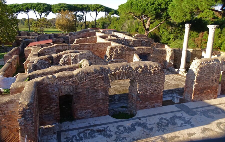 Ostia Antica archaeological site with palm tree and stone wall