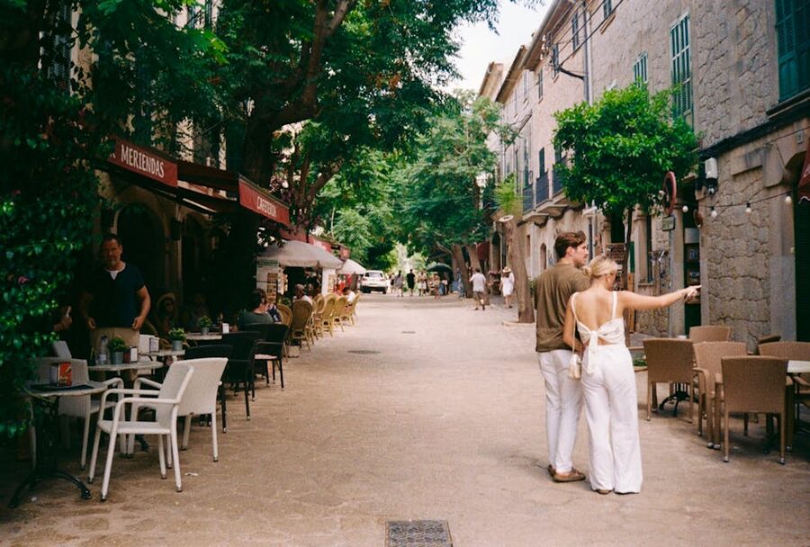 A couple walking down a quiet stone-paved street in the old town of Palma de Mallorca