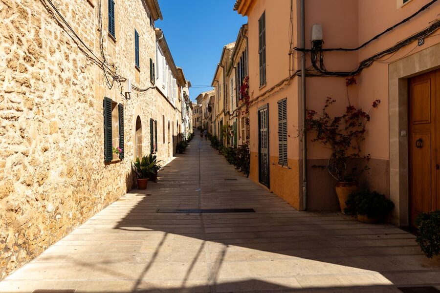 Narrow lane in Palma de Mallorca old town with stone buildings