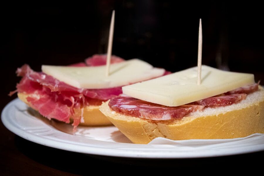 Spanish tapas plate with cured meats and cheese on a winery lunch board
