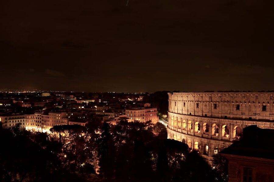 Colosseum and Rome cityscape illuminated at night