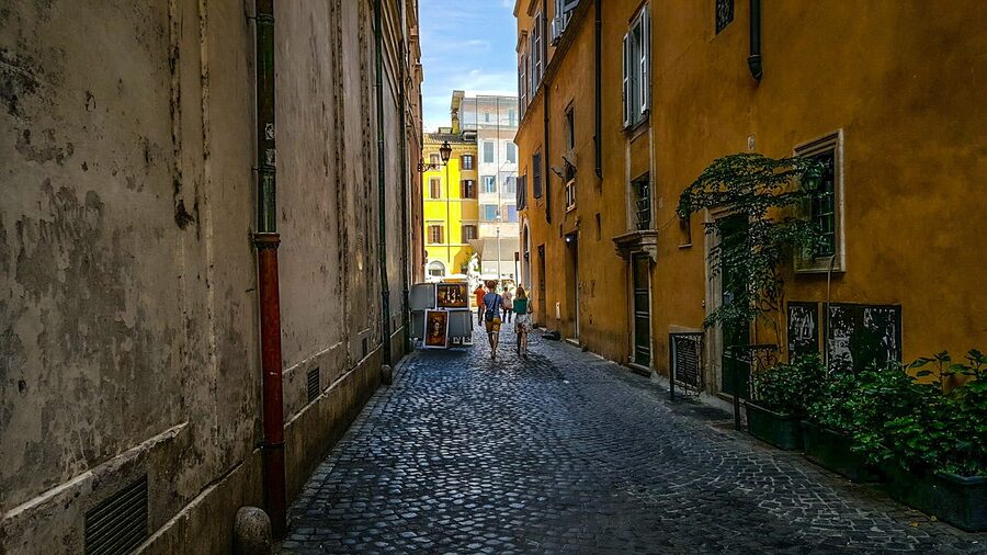 Couple walking historic Rome alley near Piazza Navona