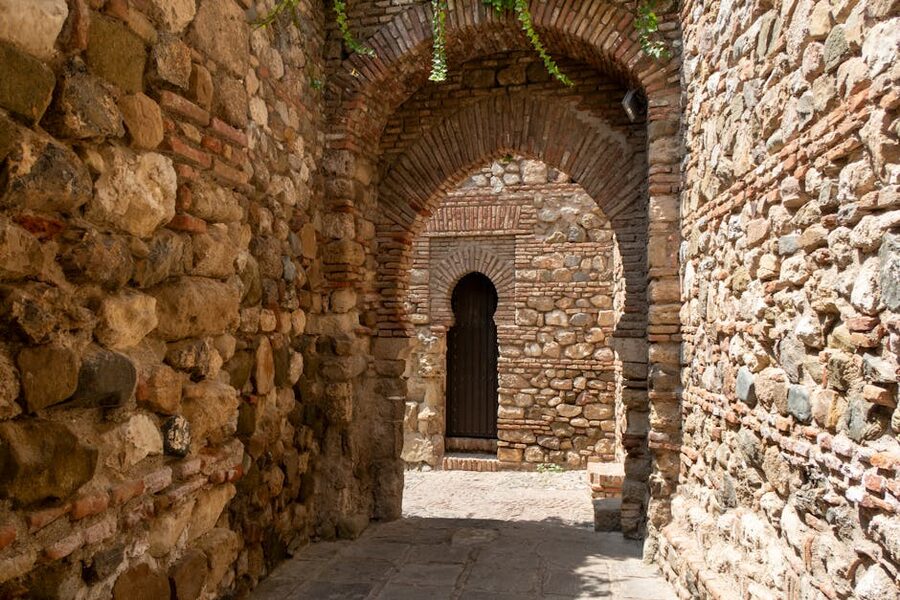 Sunlit stone archway in Málaga old town near the Picasso Museum