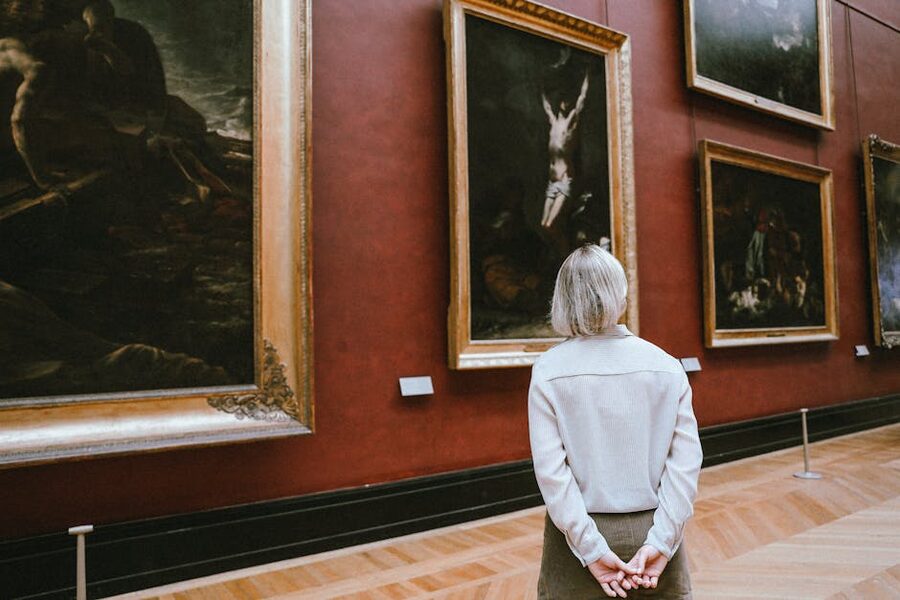 Visitor studying paintings in a quiet gallery