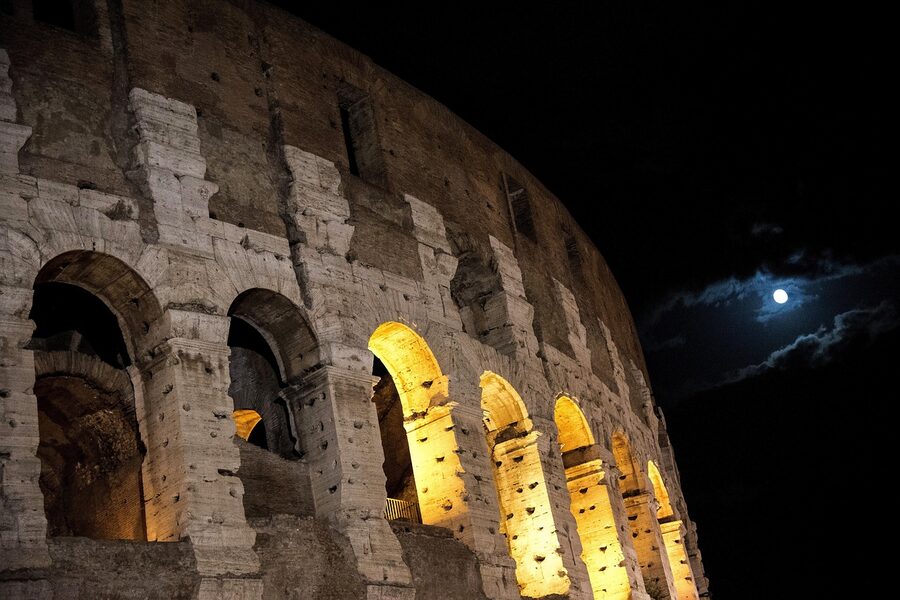 Colosseum at night with moon in the sky