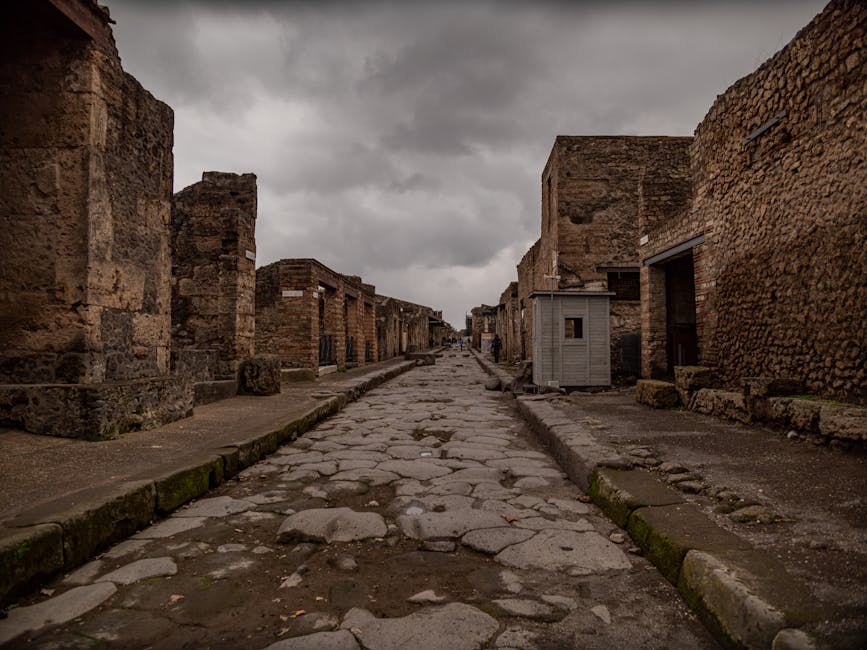 A quiet ancient street in Pompeii under an overcast sky