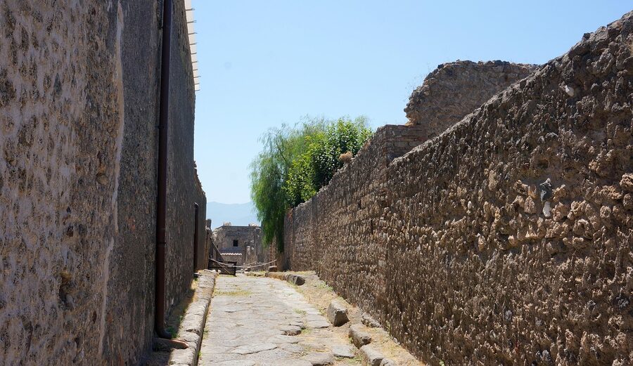 Stone alley between Pompeii's ruined walls