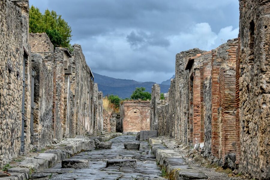 Ancient stone ruins of Pompeii with distant mountains