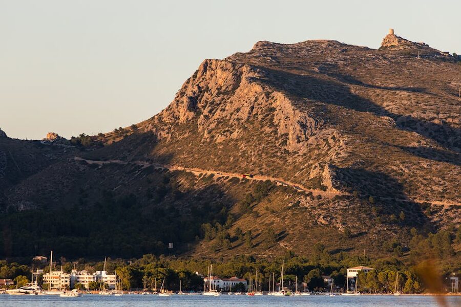 Port de Pollensa with sailboats at sunset