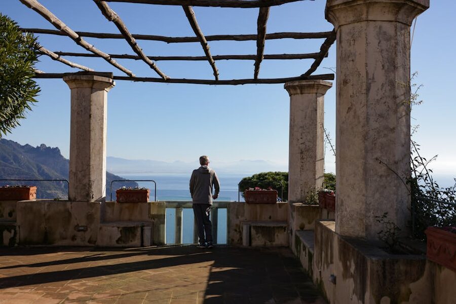 Visitor admiring Amalfi Coast view from a Ravello balcony