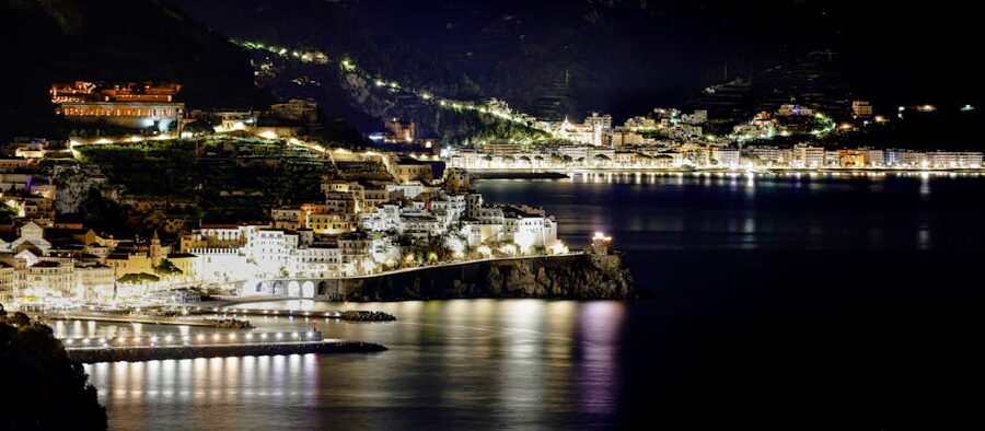 Amalfi Coast town at night with lit cityscape