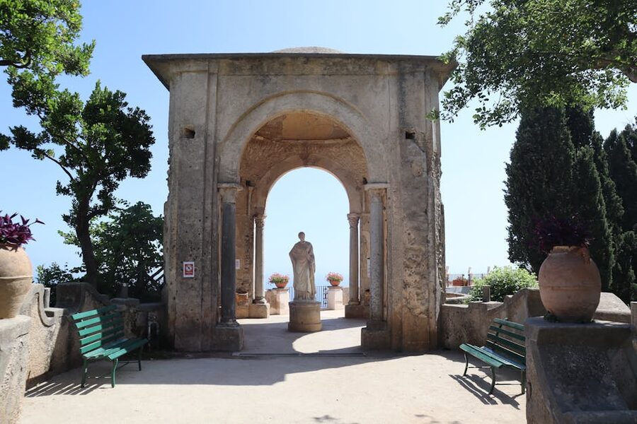 Stone arch and statue in Villa Cimbrone garden